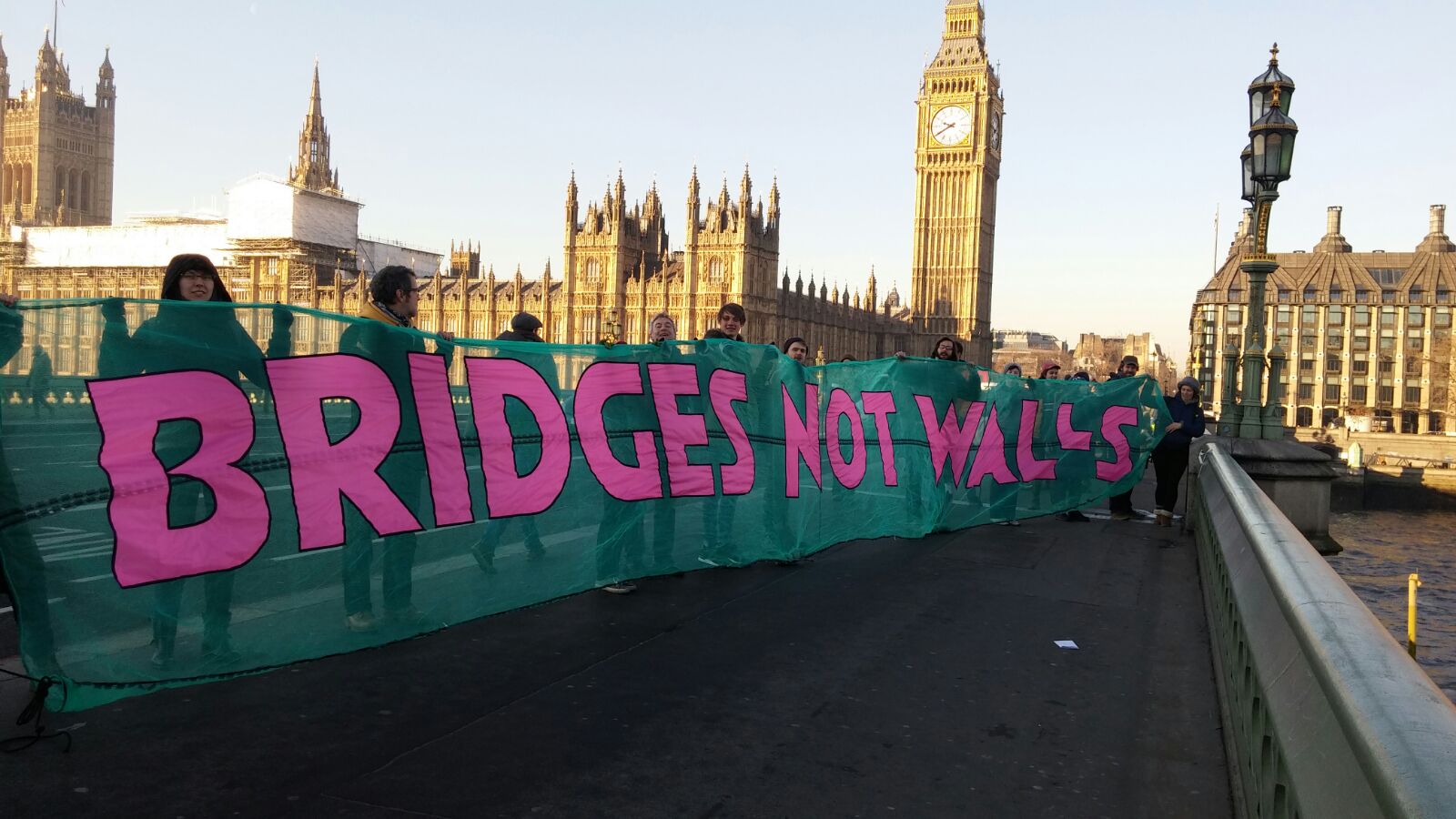Anti-Trump protesters unveil banners of solidarity on bridges around ...